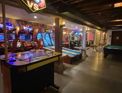 Elevated arcade bar with tons of arcade games, skee-ball, beer pong ...